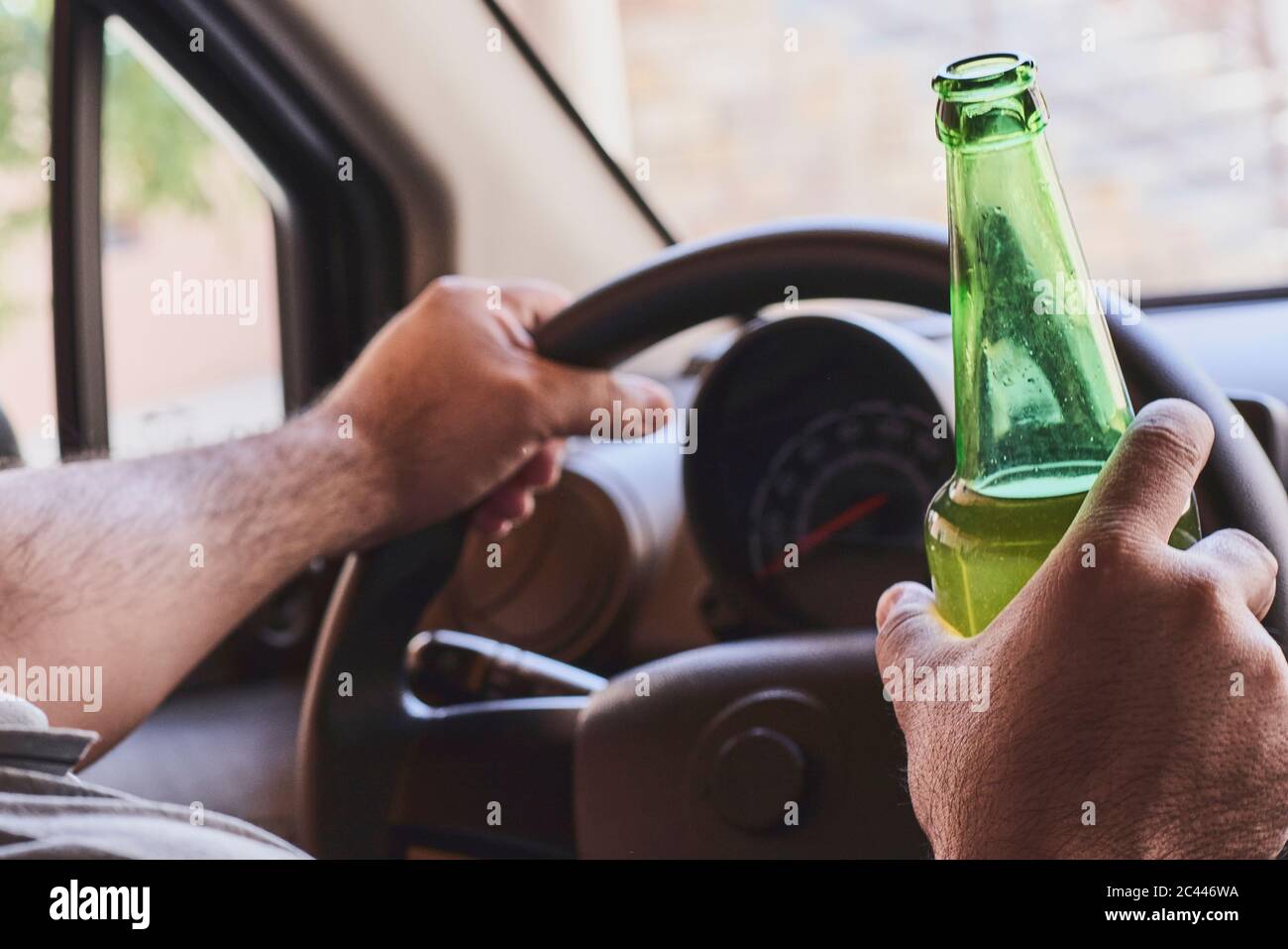 Hand holding beer bottle driving hi-res stock photography and images ...