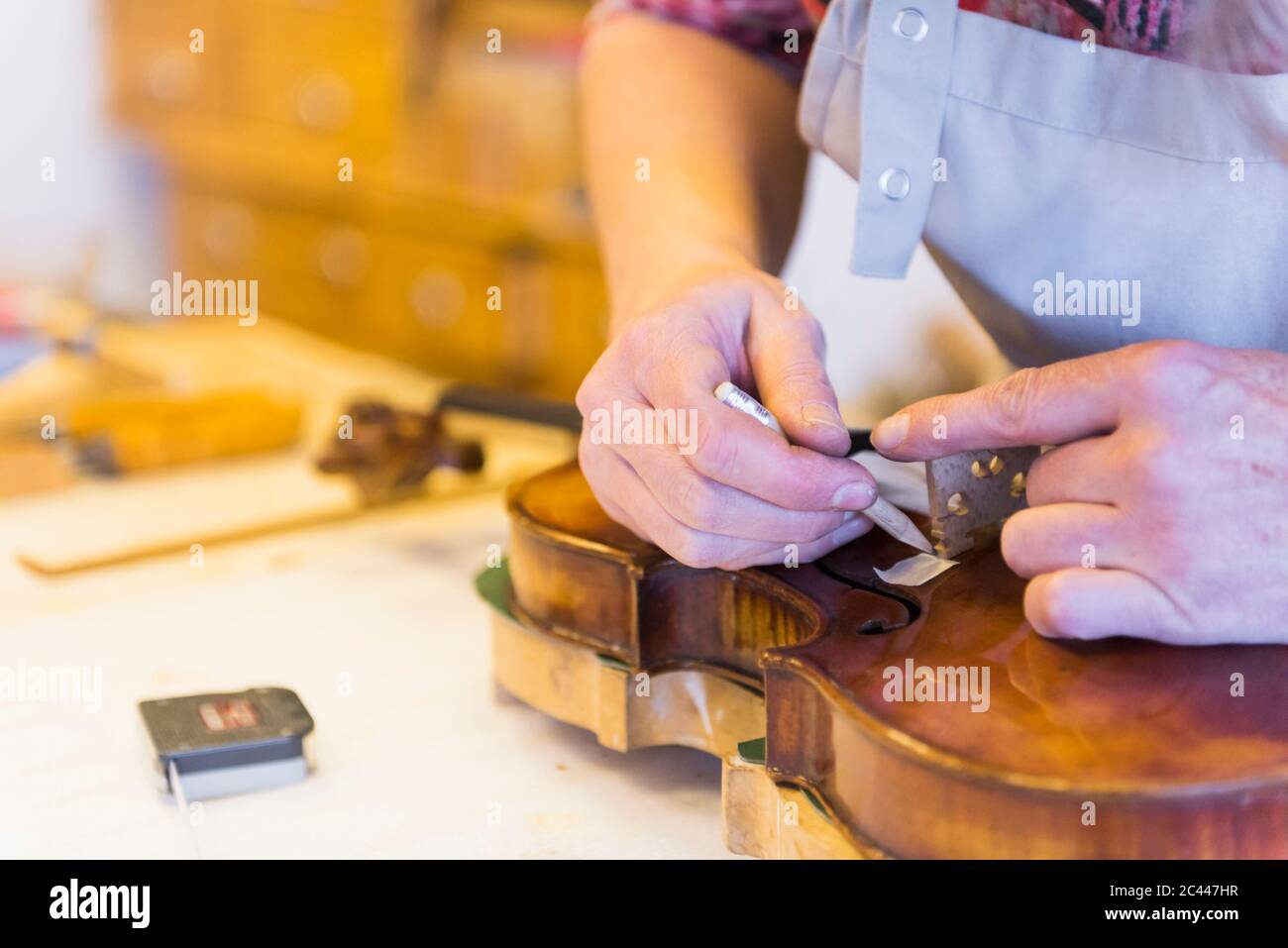 Female violin maker at work Stock Photo - Alamy