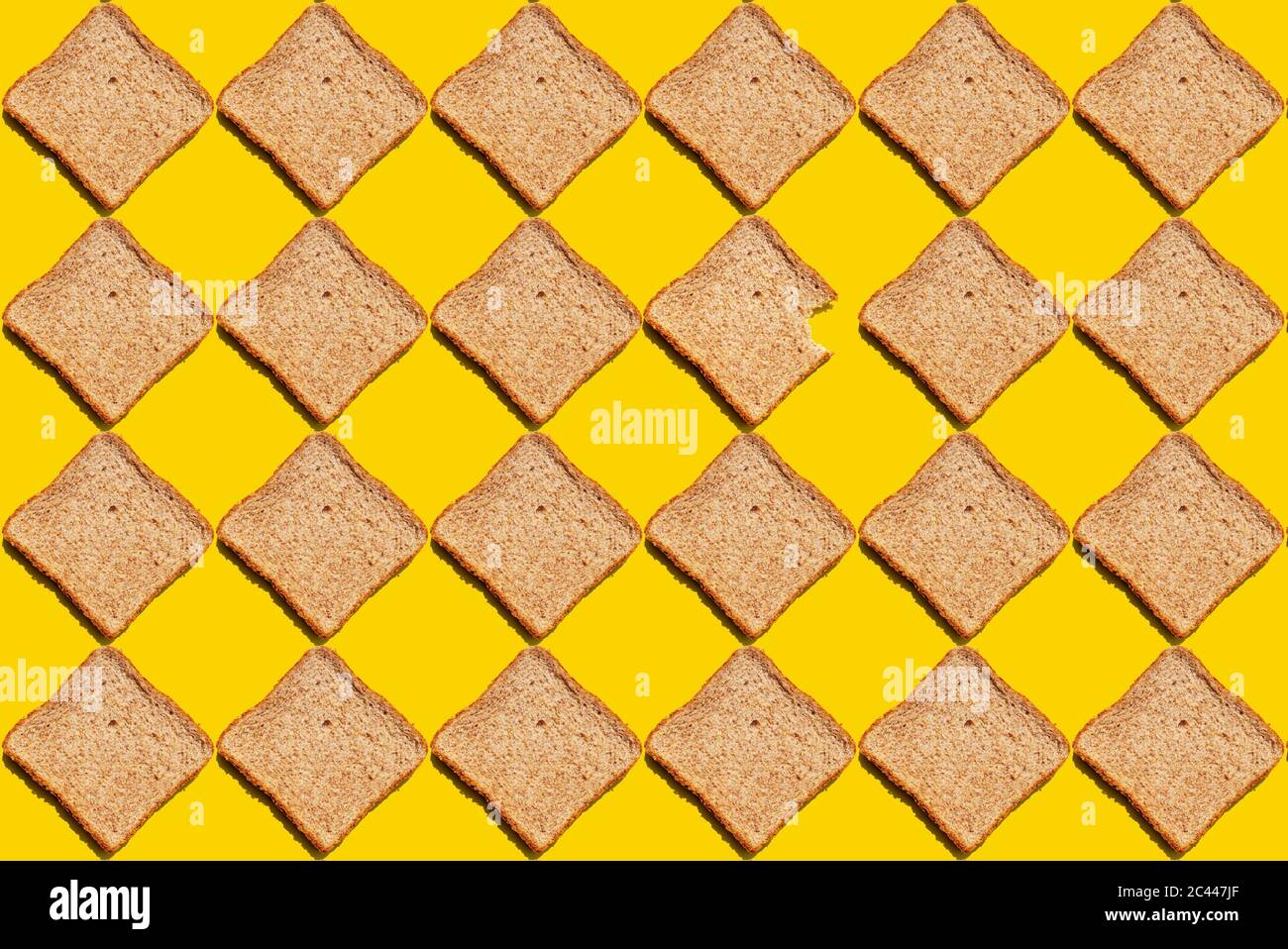 Pattern of slices of wheat bread against yellow background Stock Photo ...