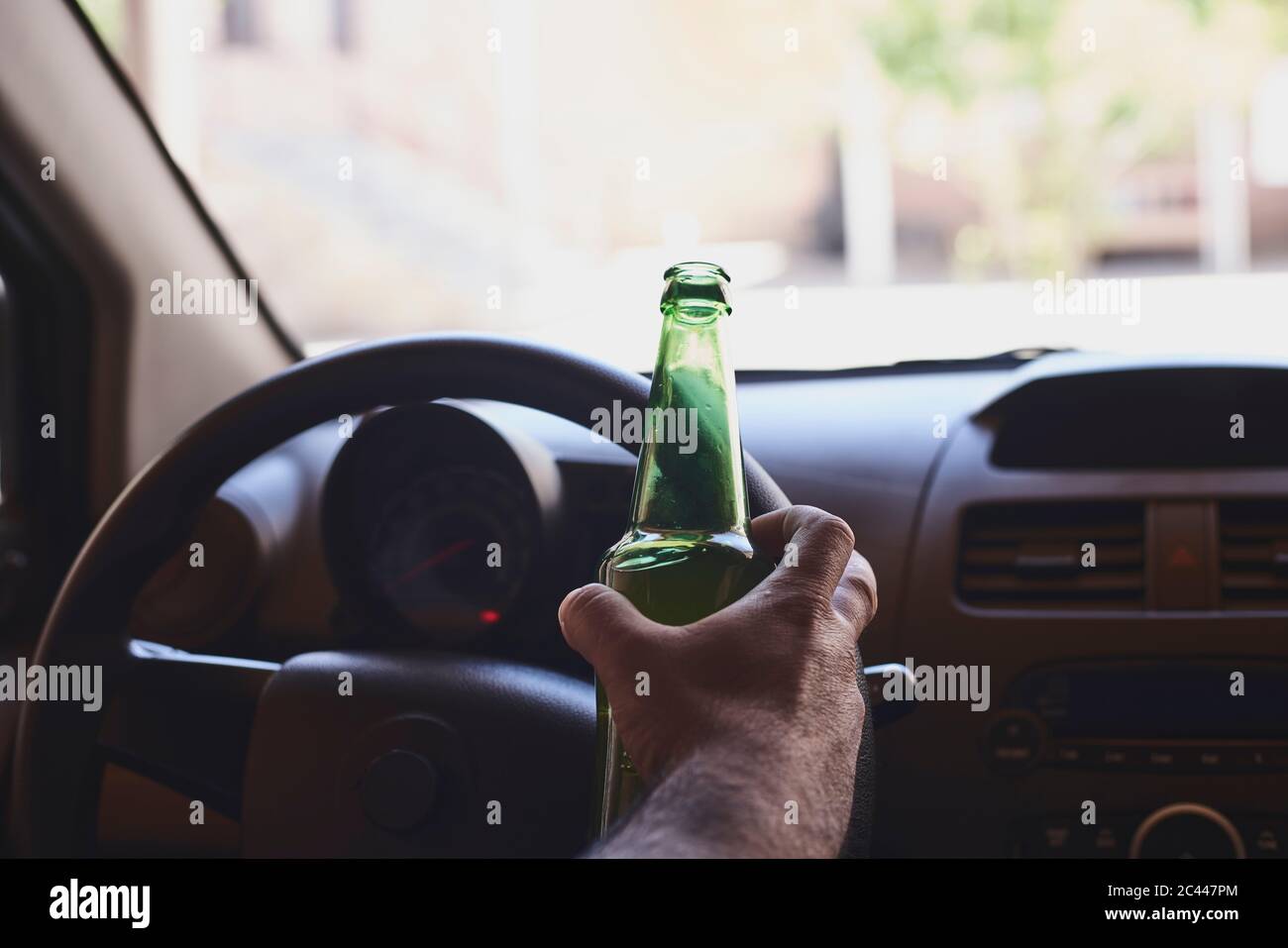 Hand holding beer bottle driving hi-res stock photography and images ...