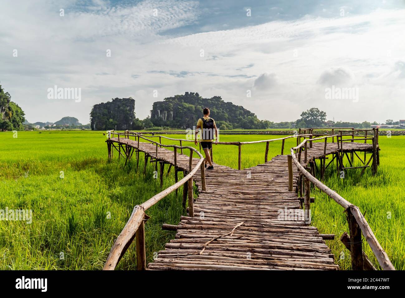Vietnam, Ninh Binh Province, Ninh Binh, Male tourist walking along ...