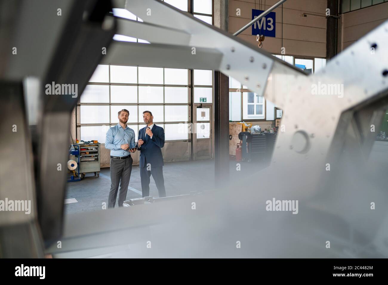 Two businessmen having a meeting in a factory Stock Photo - Alamy