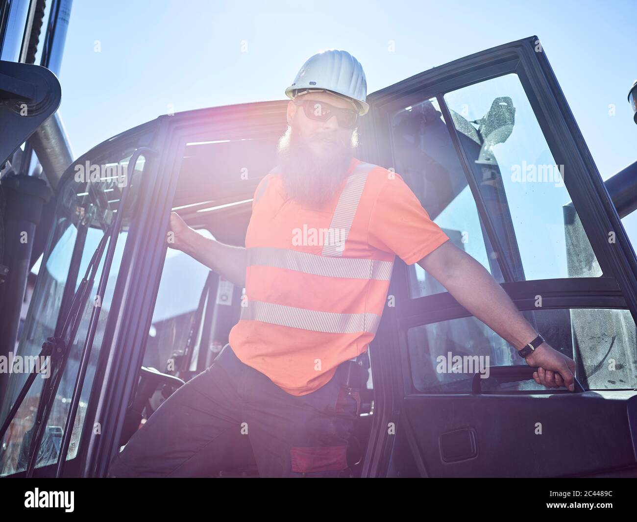Construction worker wearing reflecting clothing hardhat standing by ...