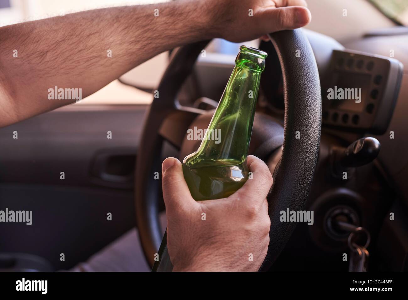 Hand holding beer bottle driving hi-res stock photography and images ...