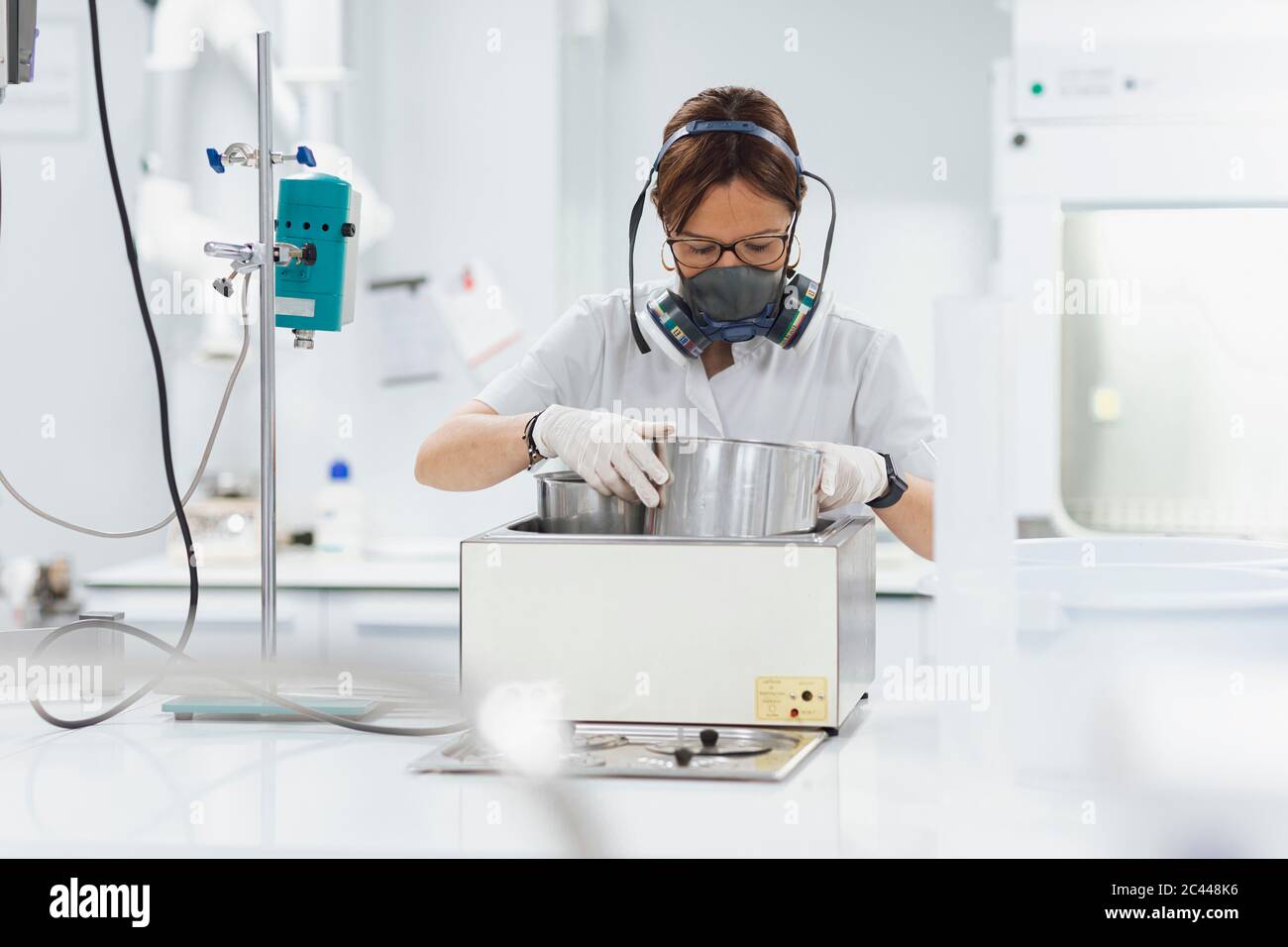 Confident female technician doing research while using medical ...