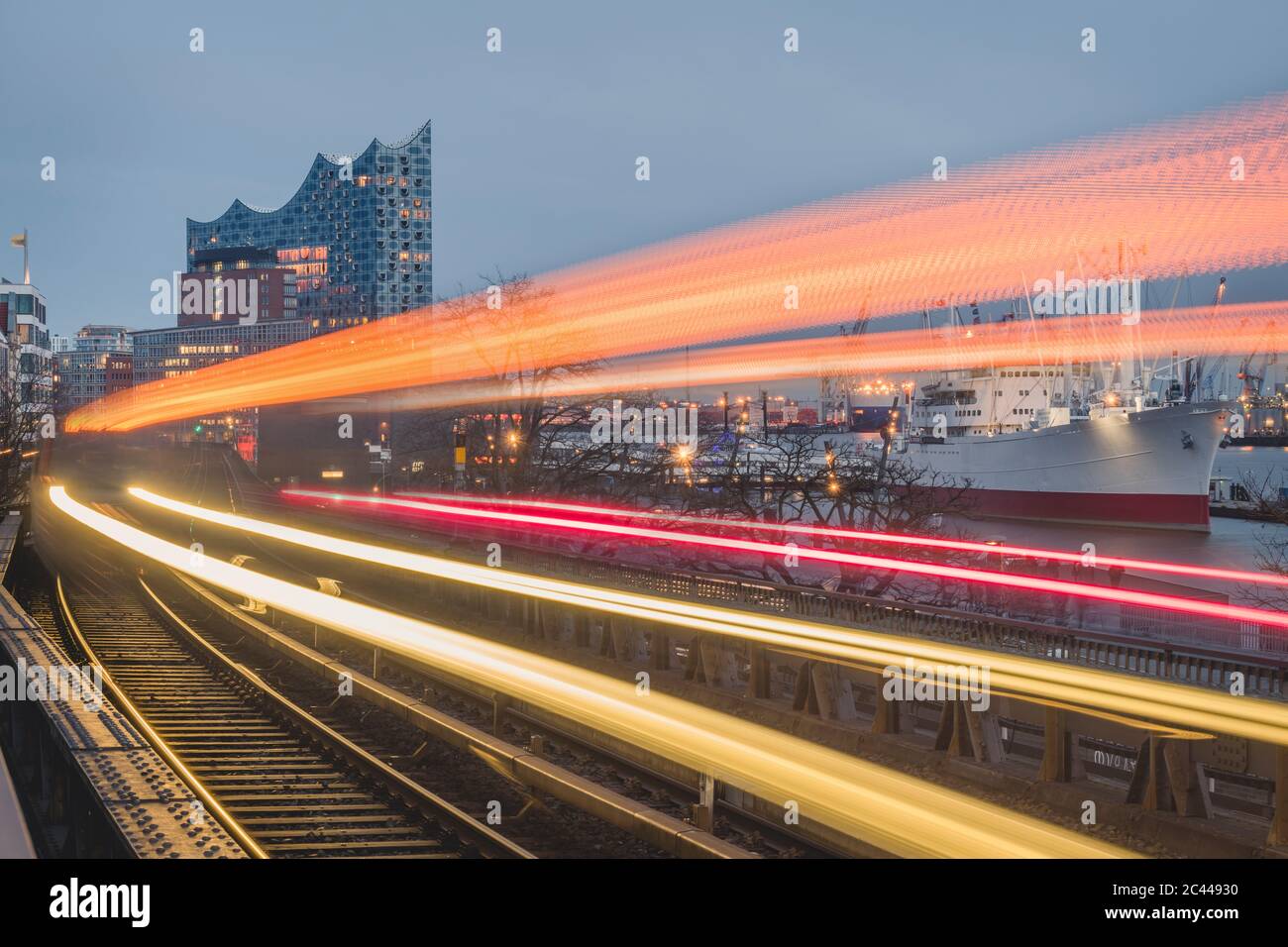 Germany, Hamburg, Train light trails along elevated railway track at ...