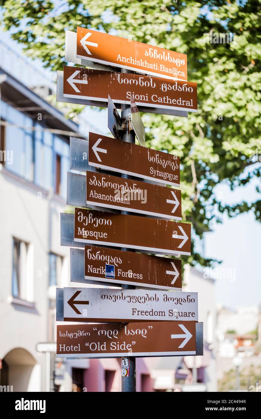 Road signs against building in city Stock Photo - Alamy