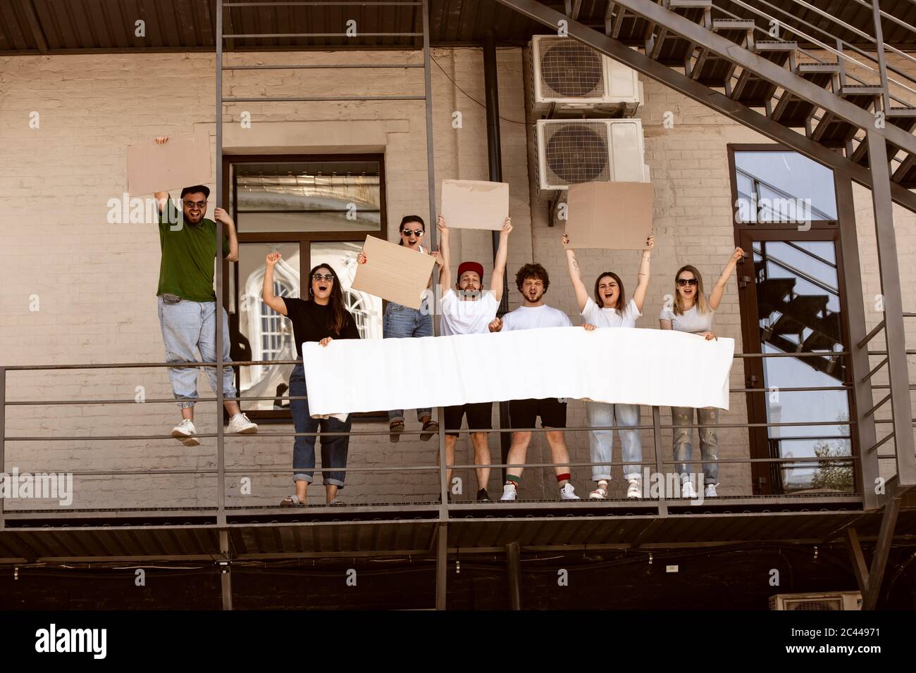 Diverse group of people protesting with blank sign. Protest against ...