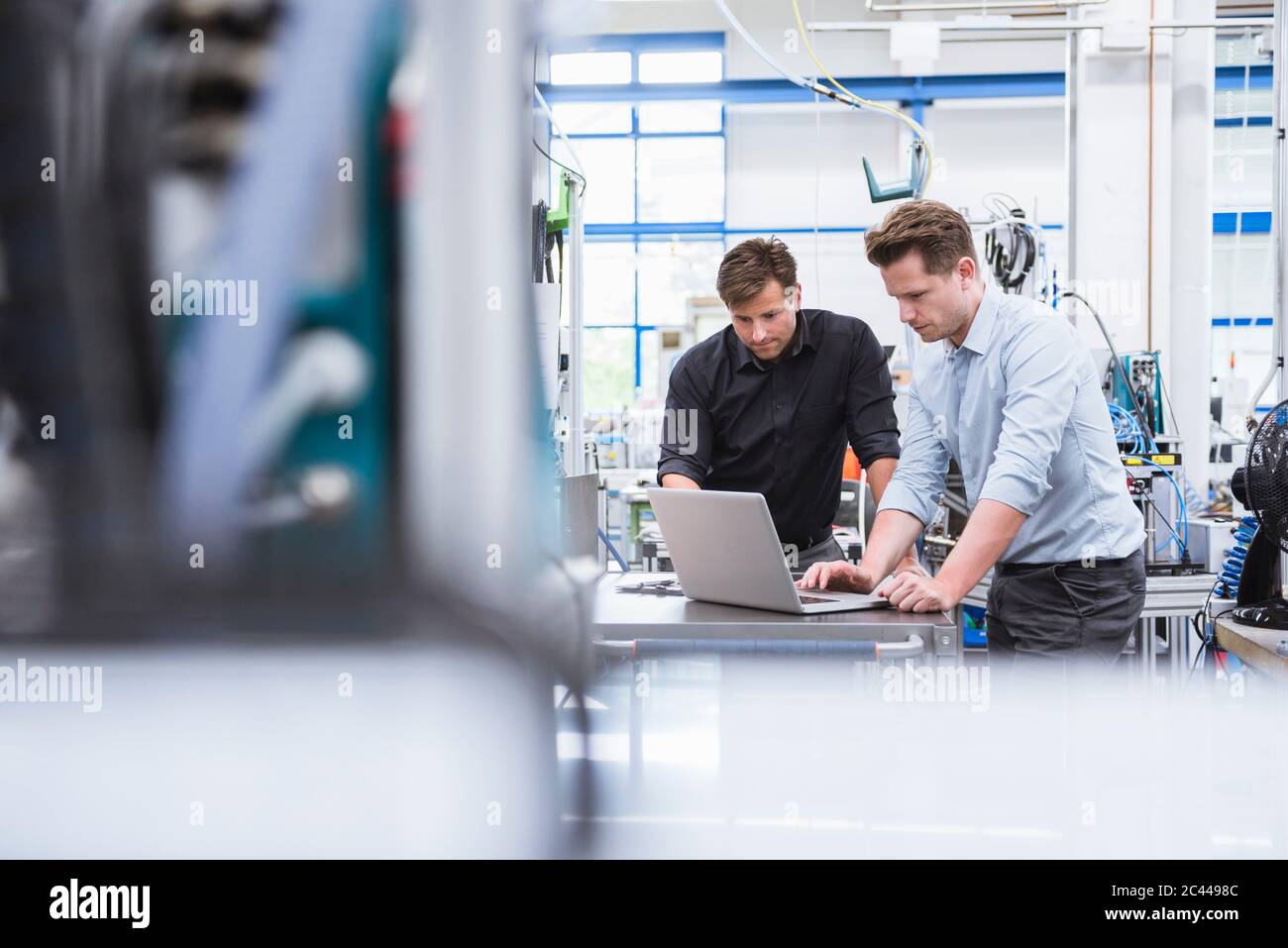 Two men with laptop computer hi-res stock photography and images - Alamy