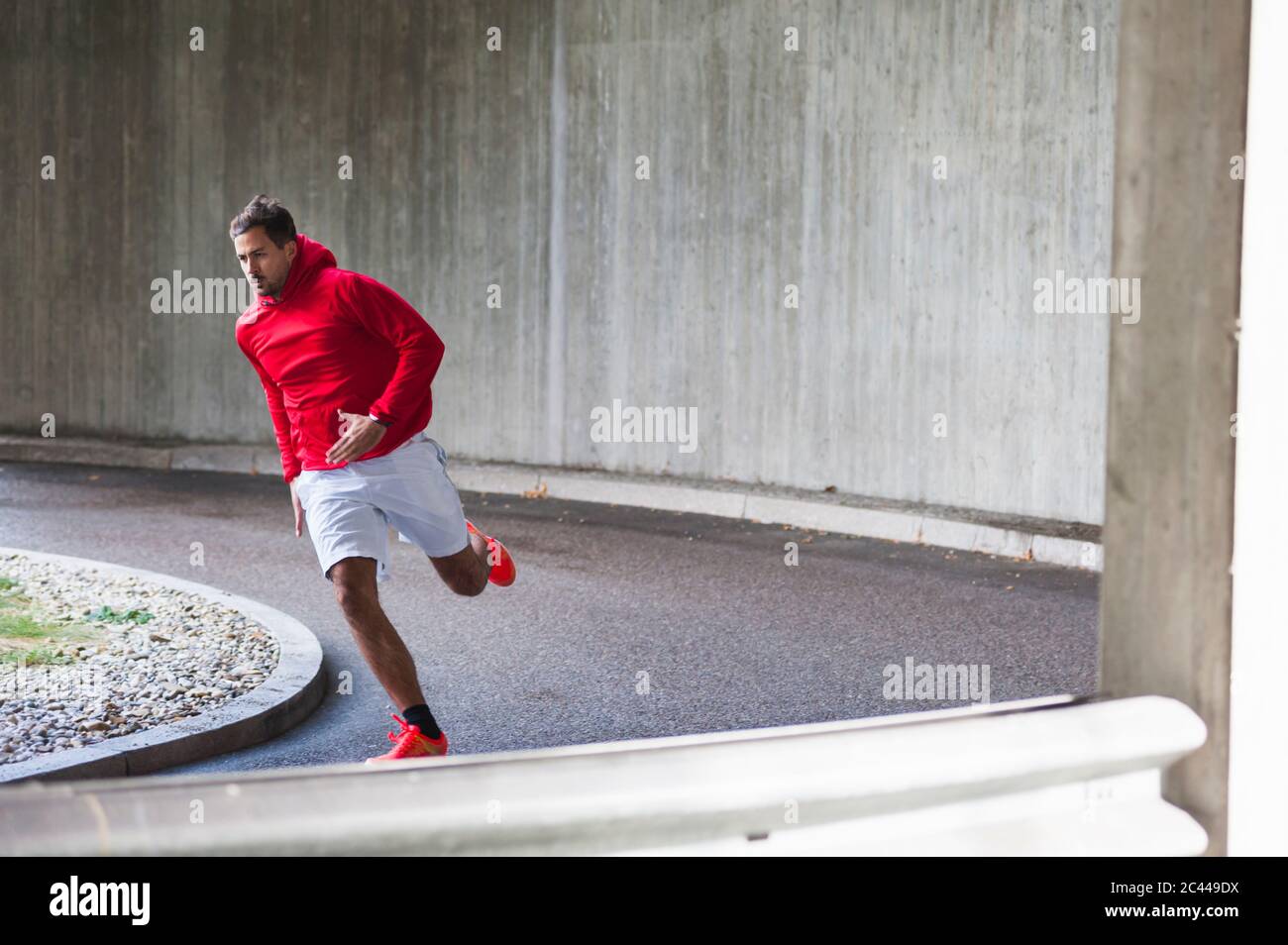 Young man running on a road Stock Photo - Alamy