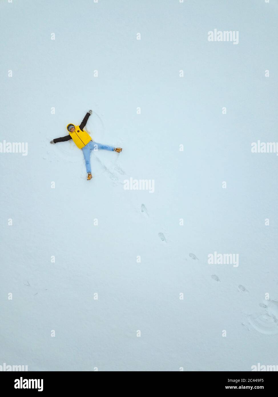 Russia, Aerial view of adult woman making snow angel Stock Photo - Alamy