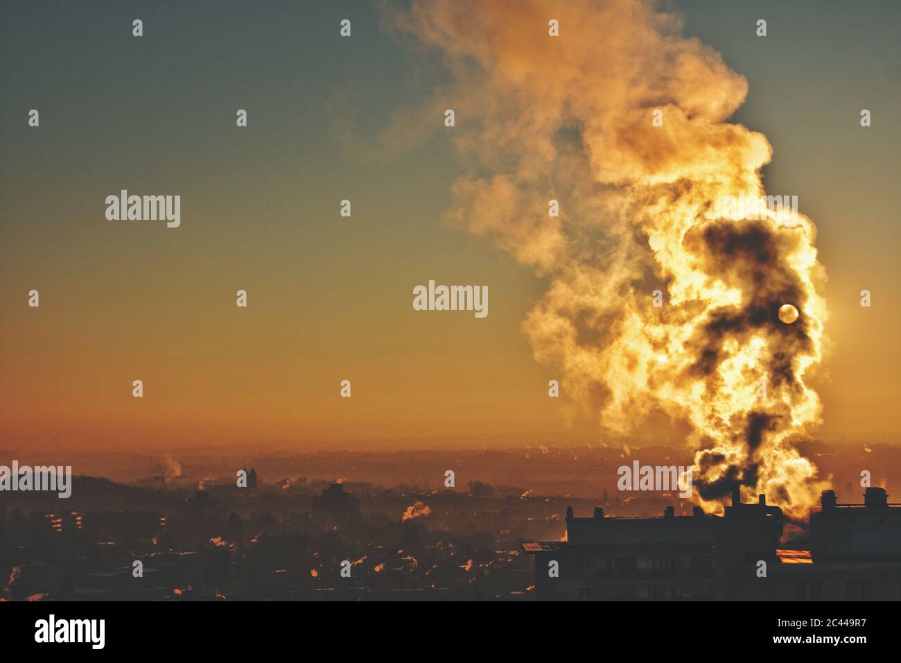 Lots of smoke coming out to the sky from a factory chimney. Moody ...