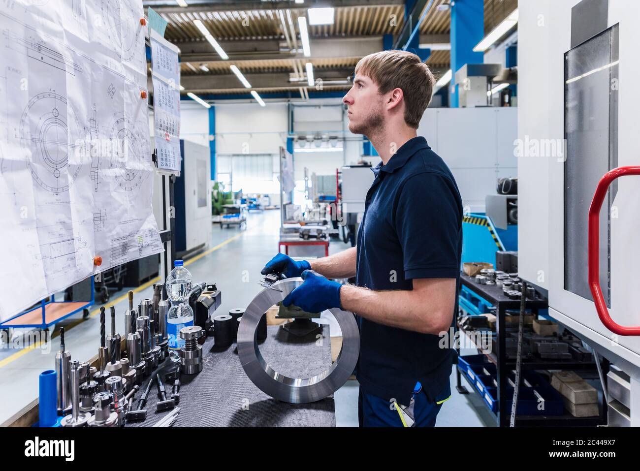 Man working at workbench in a metalworking factory Stock Photo - Alamy