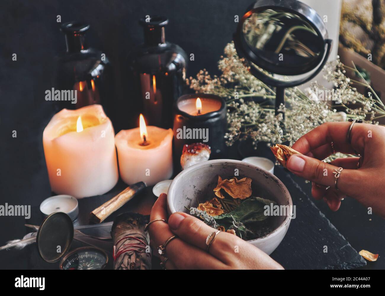 Female wiccan witch holding grey clay pot in her hands preparing ...