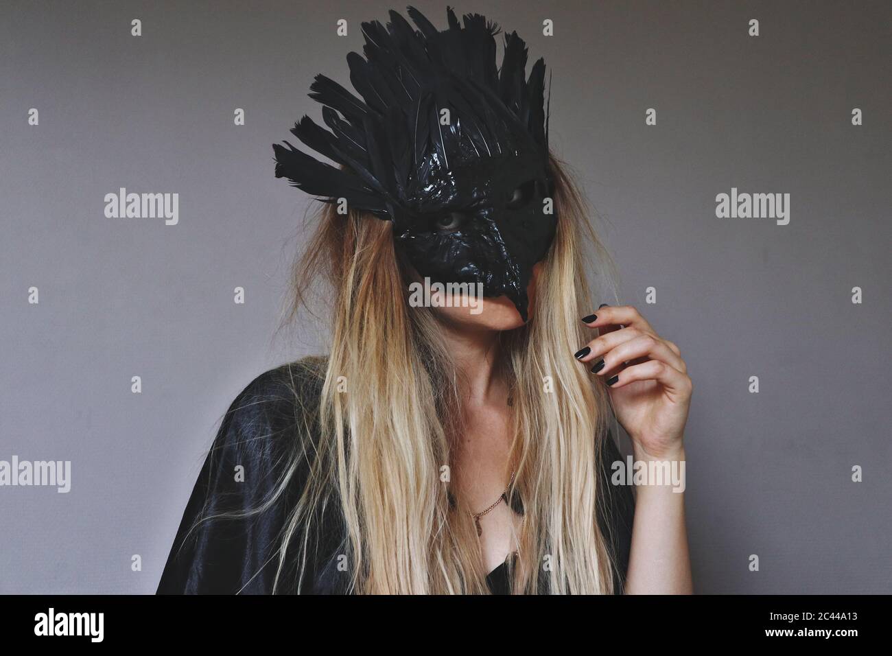 Young female wiccan witch wearing a Samhain hand made raven mask witch ...