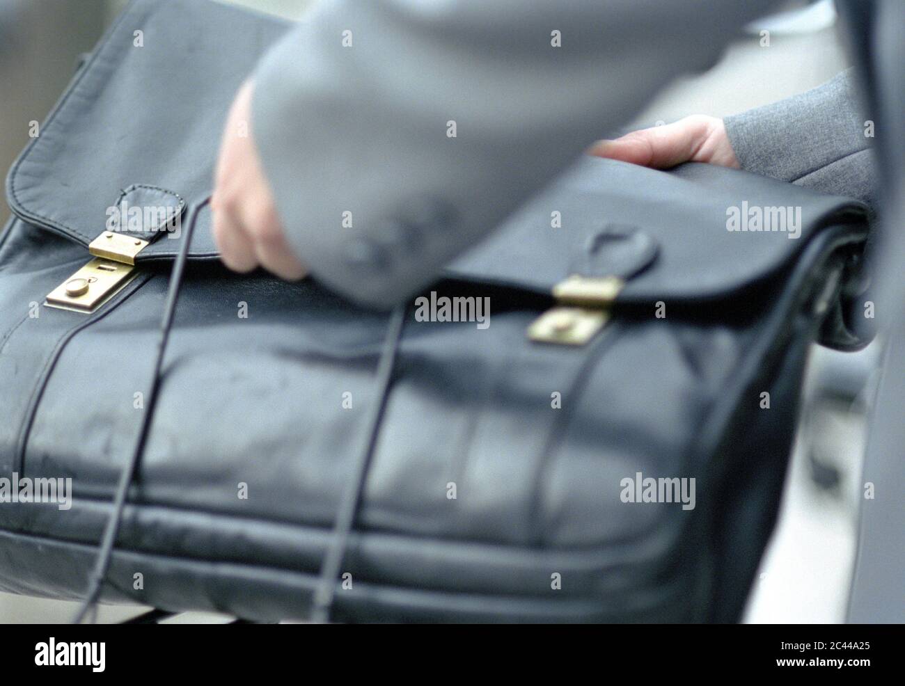 Businesswoman takes briefcase from the luggage rack Stock Photo - Alamy
