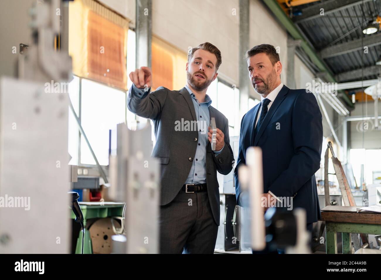 Two businessmen having a meeting in a factory Stock Photo - Alamy