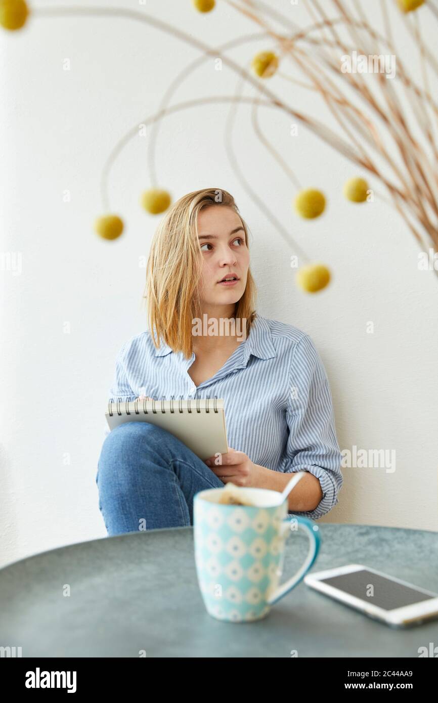 Portrait of young woman drawing at home Stock Photo - Alamy
