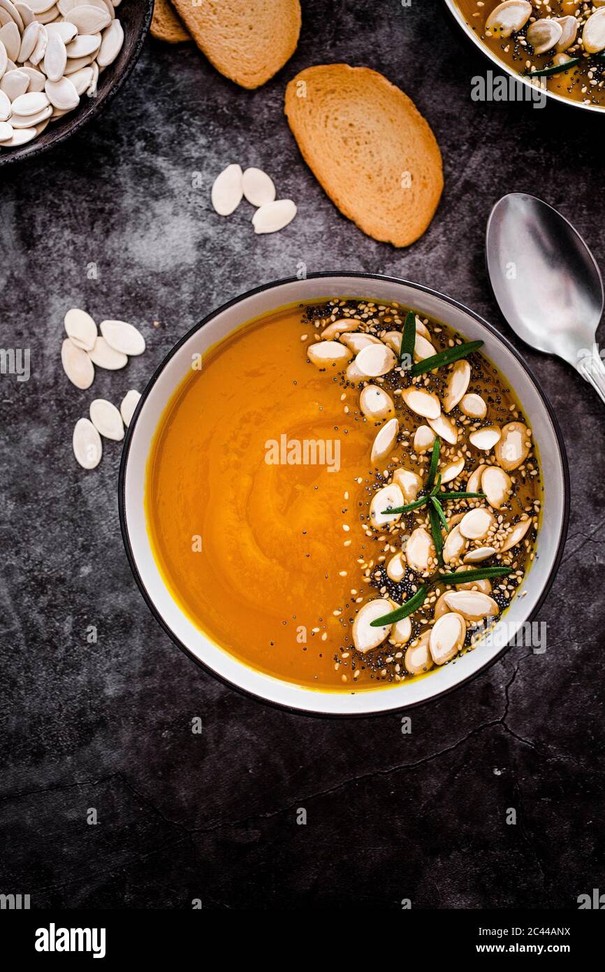 Overhead view of pumpkin soup with seeds Stock Photo - Alamy