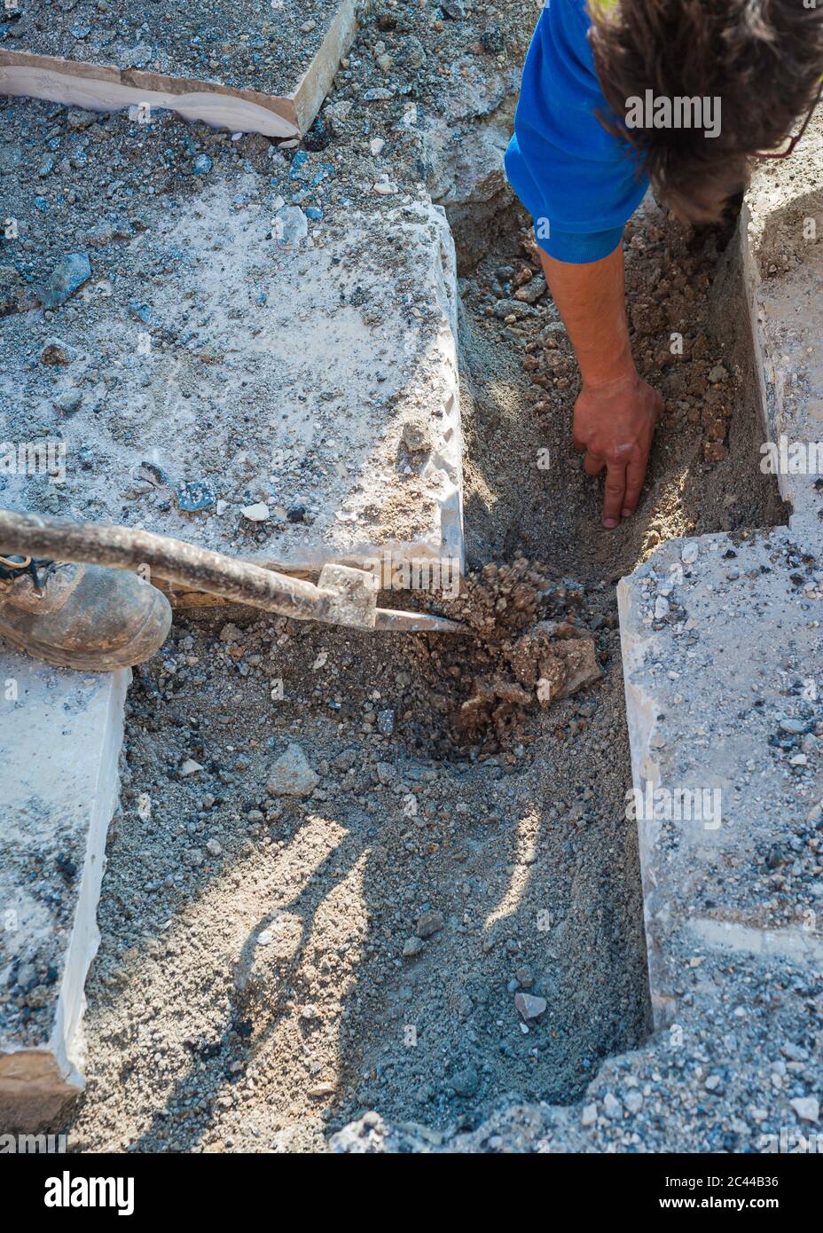 Construction worker is performing a hand-excavation in a restricted ...