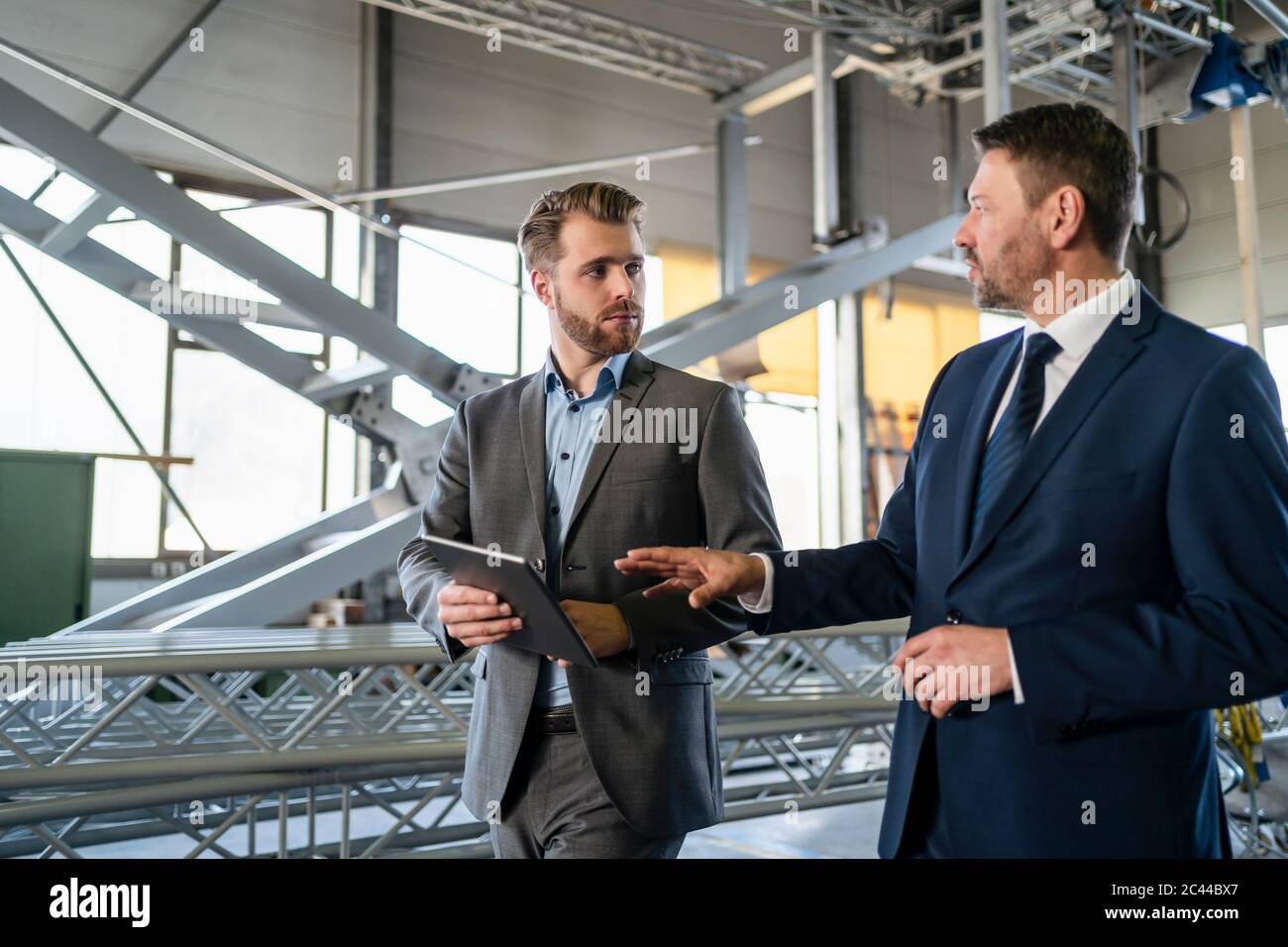 Two businessmen with tablet having a meeting in a factory Stock Photo ...