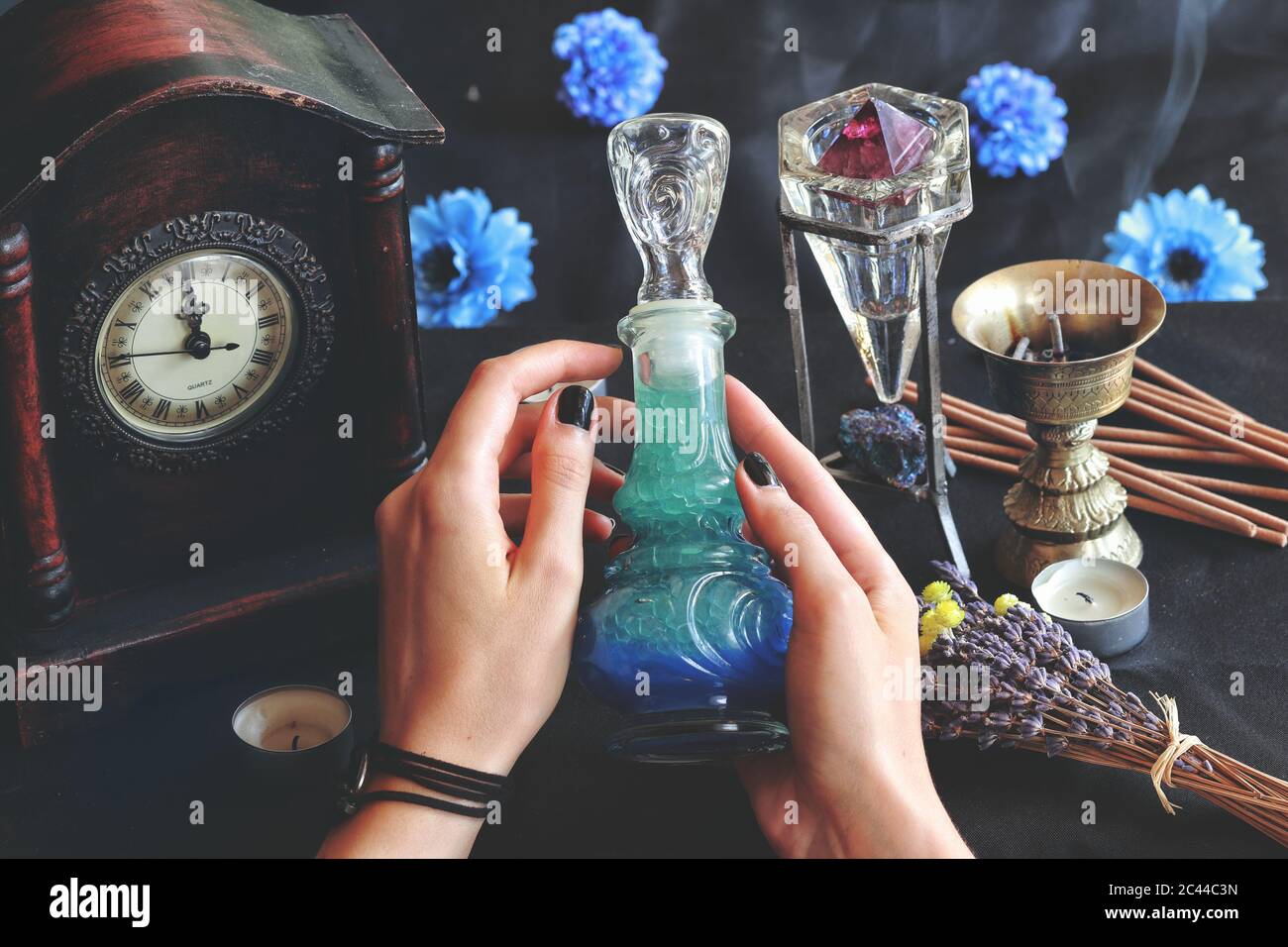 Wiccan witch holding a lucid dreaming good night potion in her hands at ...