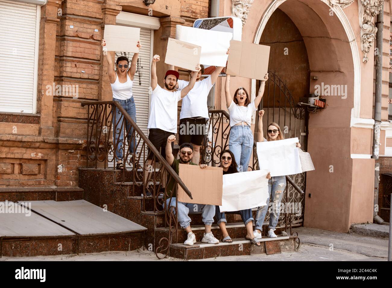 Diverse group of people protesting with blank sign. Protest against ...