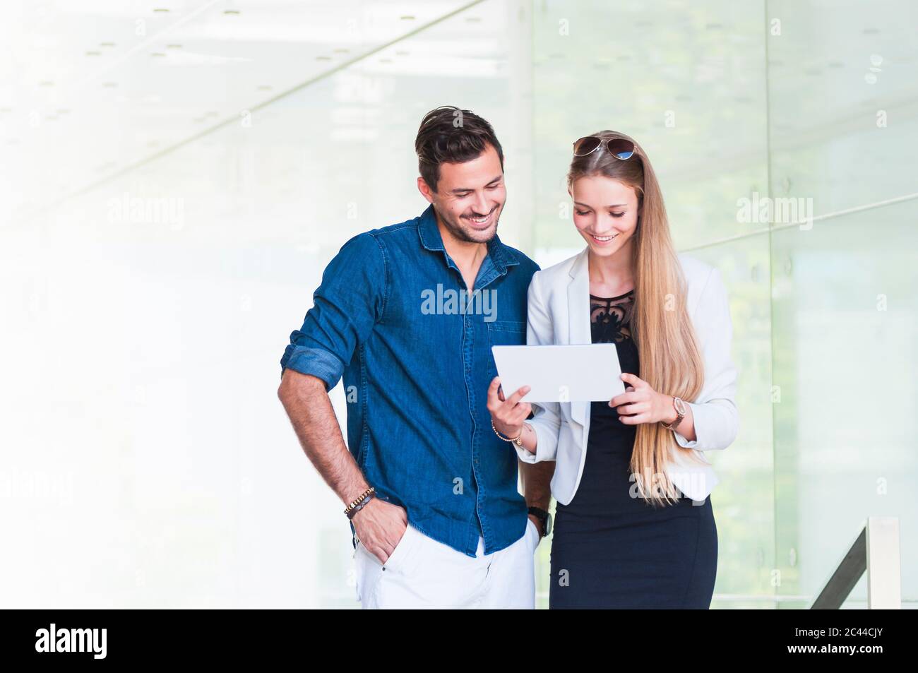 Two business people looking at digital tablet Stock Photo - Alamy