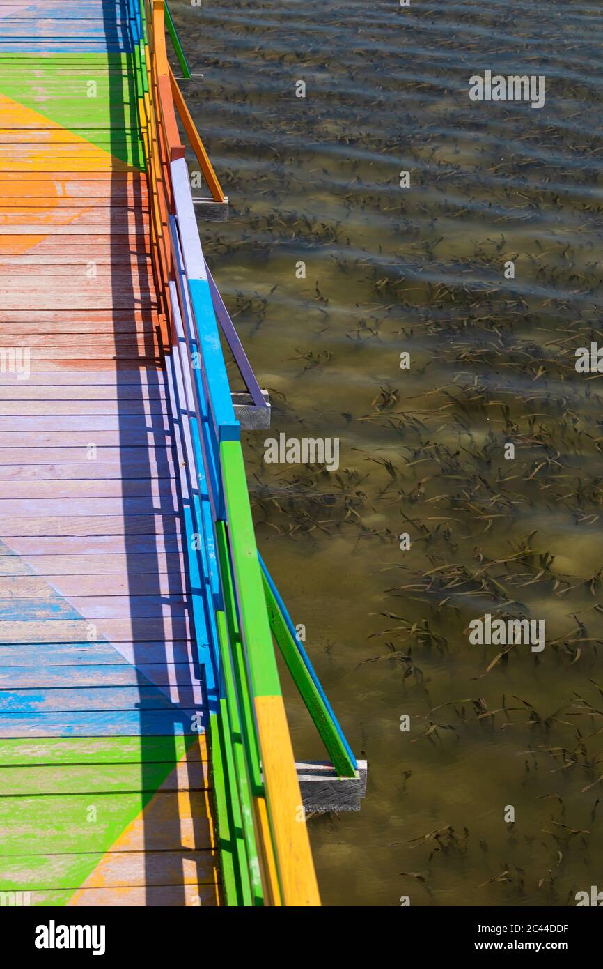 Wooden promenade decorated with vibrant and diverse colors, facing the ...