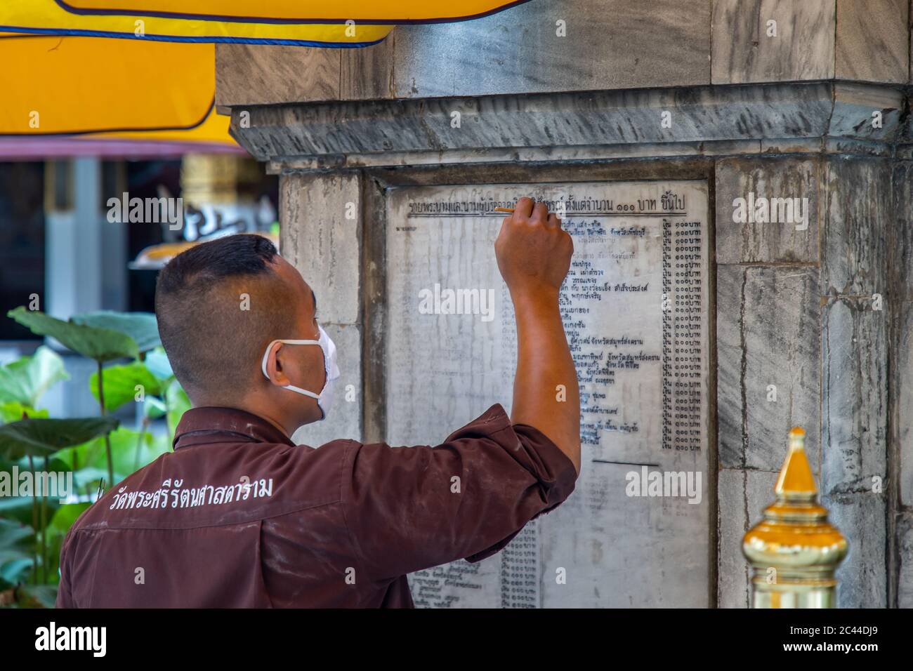 Bangkok, Thailand - Jun 19, 2020 : Temple staff is writing the donator ...