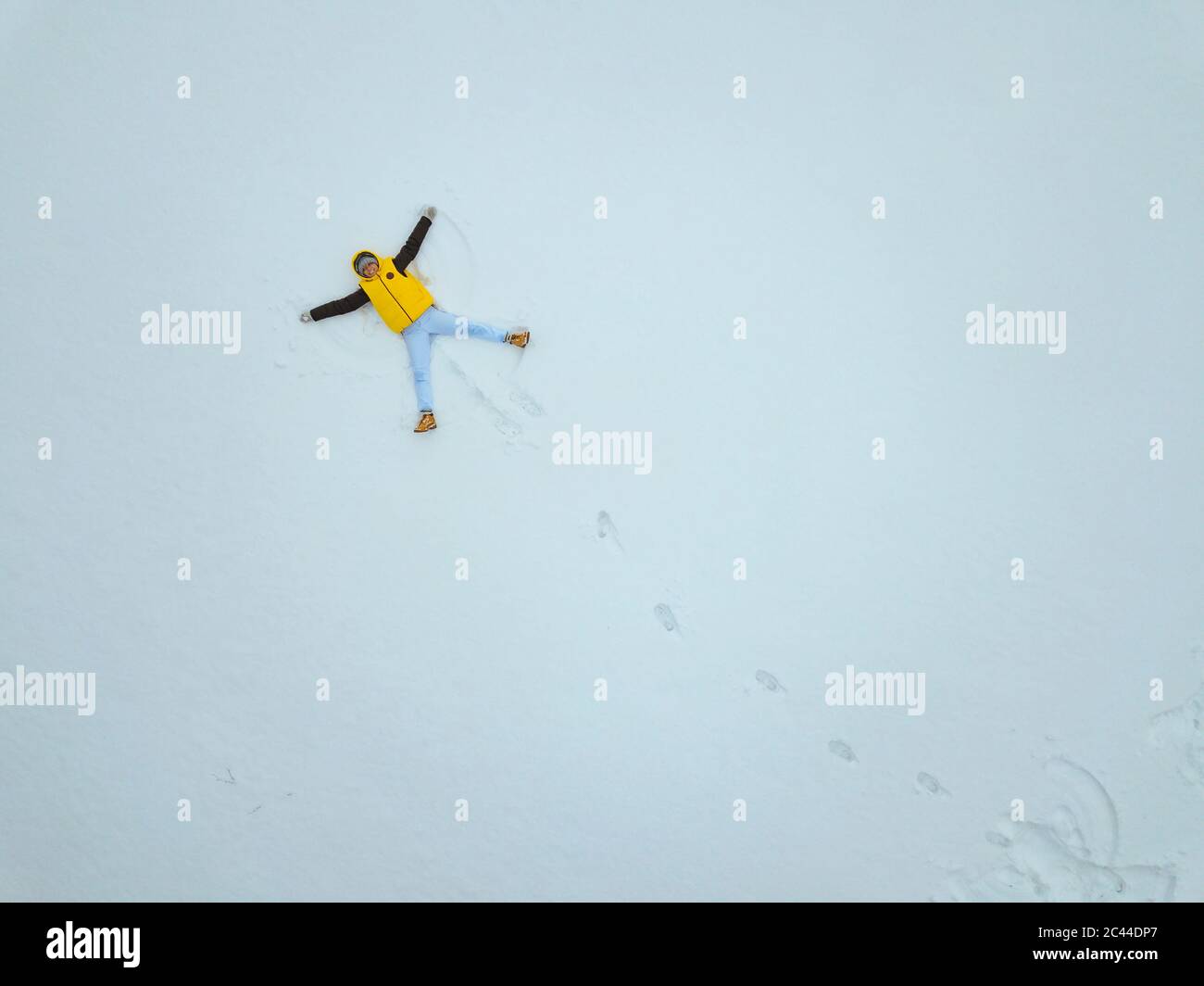 Russia, Aerial view of adult woman making snow angel Stock Photo - Alamy