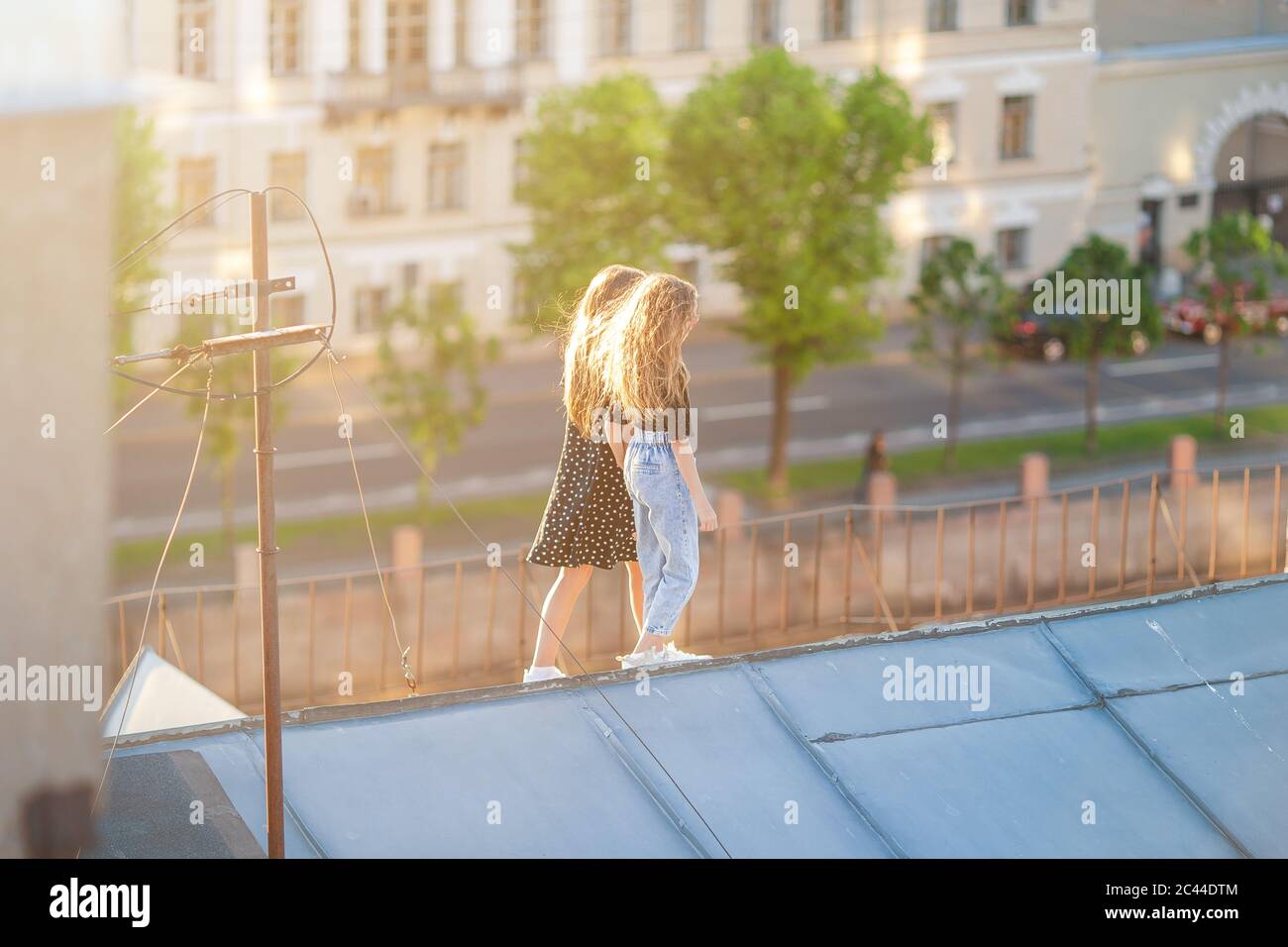 Cute girlson rooftop enjoying with view of beautiful sunset in Sankt ...