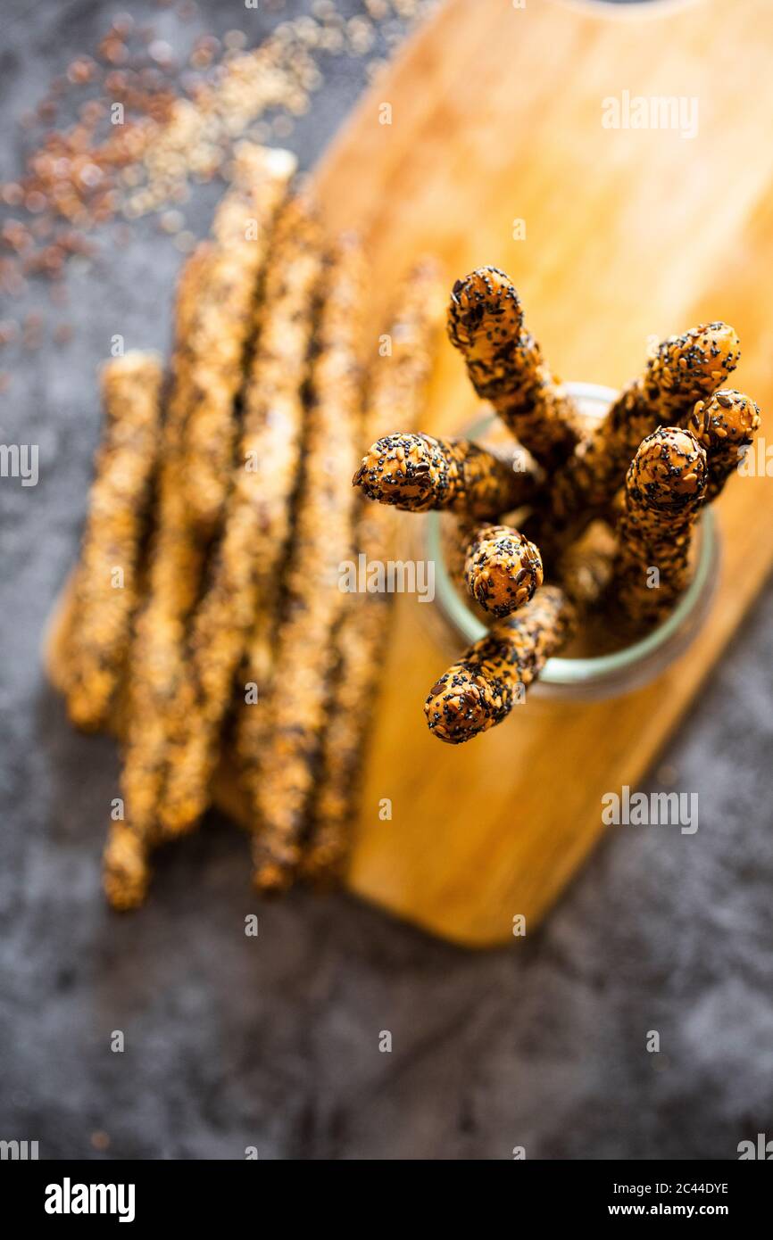 Fresh Italian grissini breadsticks with sesame, flax and poppy seeds ...