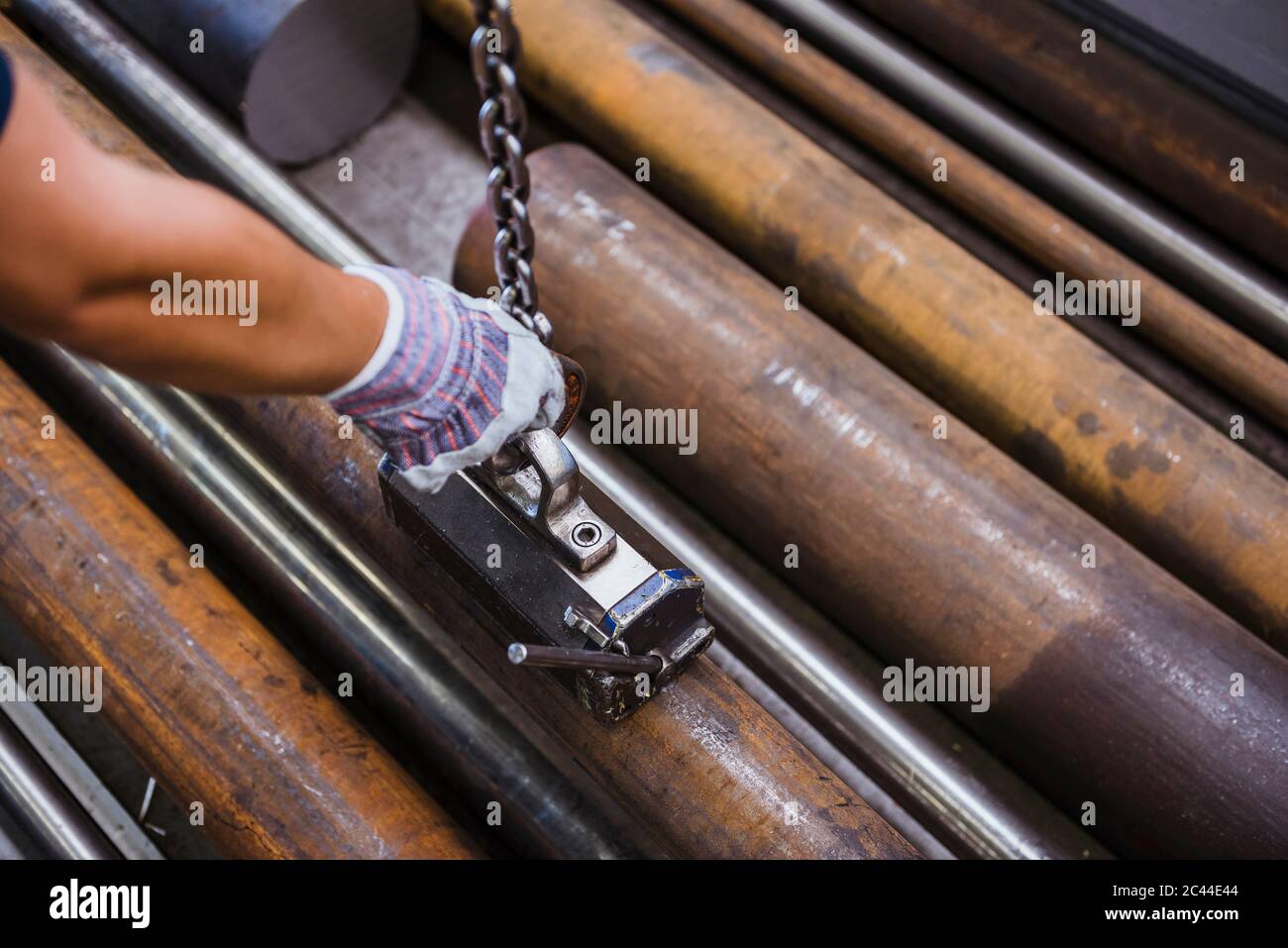 Close-up of man working with metal bars in a factory Stock Photo - Alamy