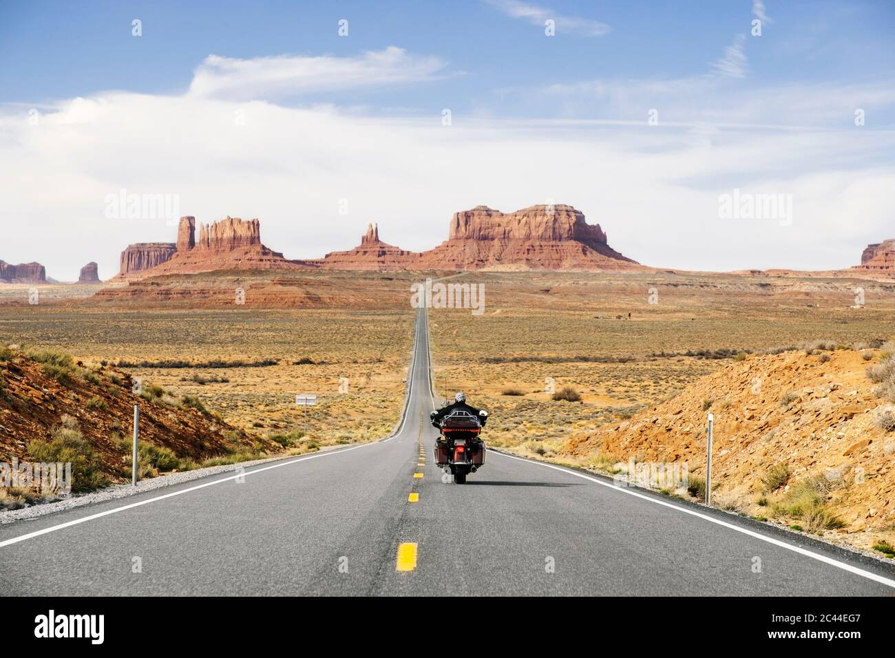 Rear view man riding motorcycle on the desert road hi-res stock ...