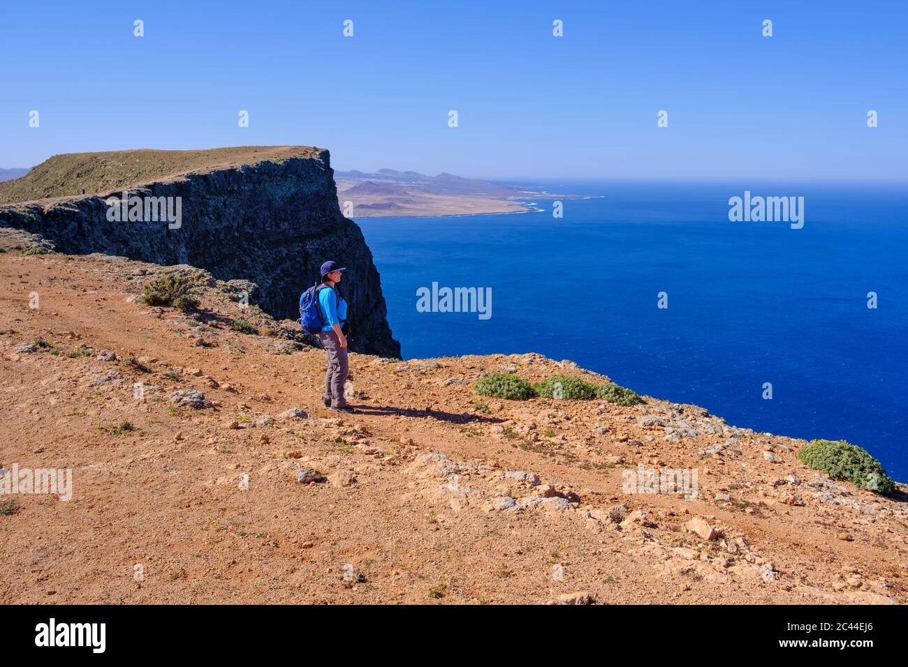 Female hiker admiring sea edge coastal cliff hi-res stock photography ...