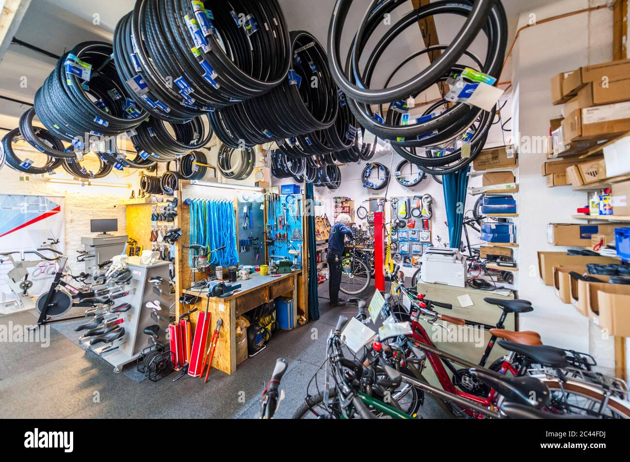 Bicycle mechanic working in bike shop Stock Photo - Alamy