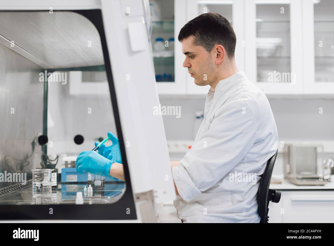 Male healthcare worker doing research in pharmaceutical laboratory ...