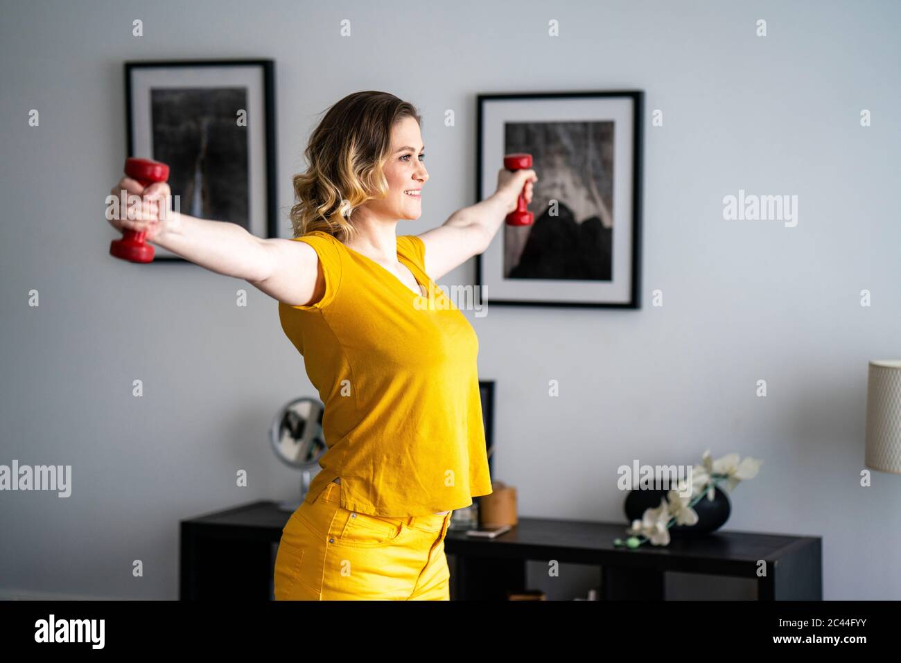 Woman doing home workout with dumbbells Stock Photo - Alamy