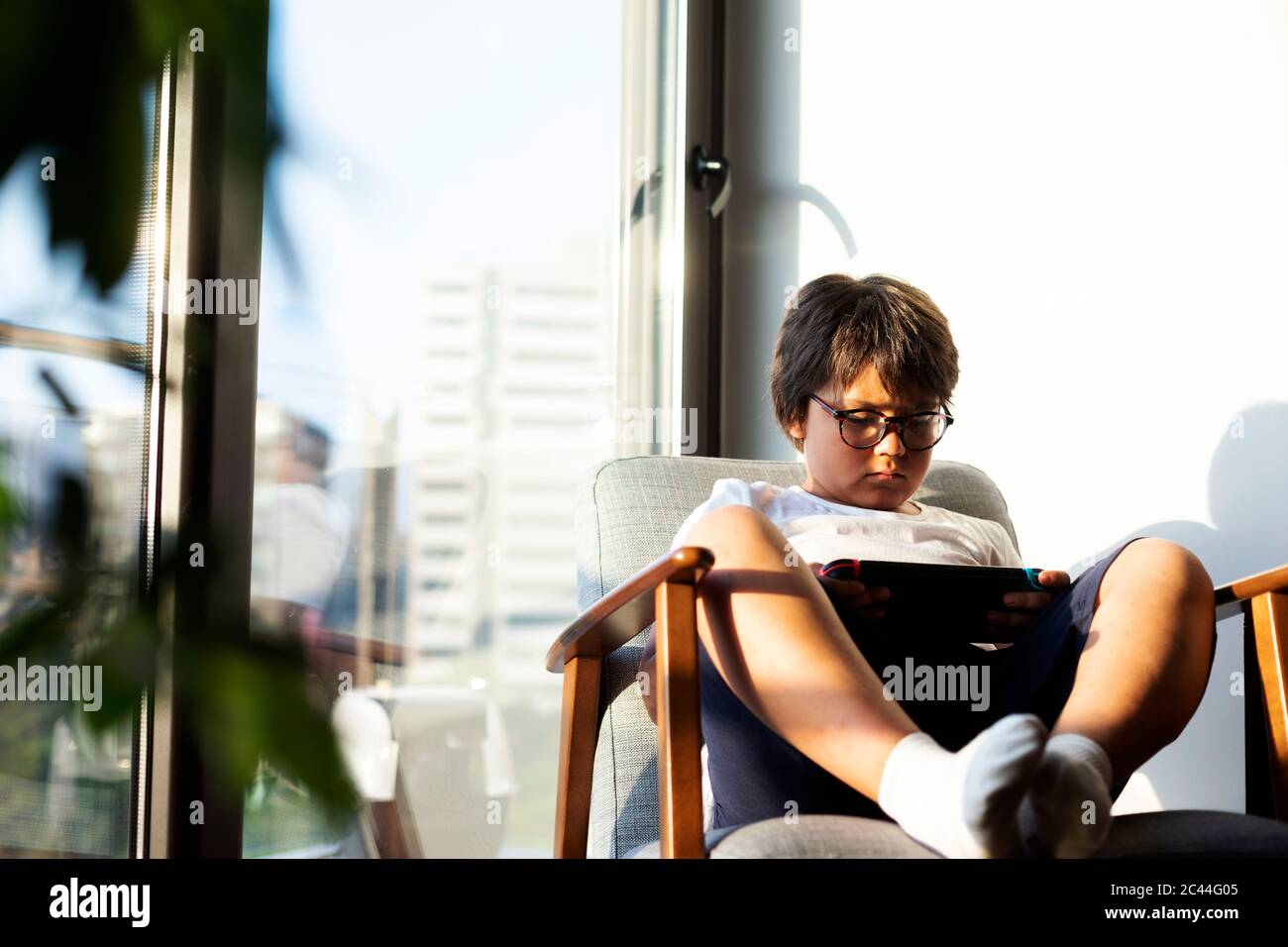 Boy playing video game on a games console Stock Photo - Alamy