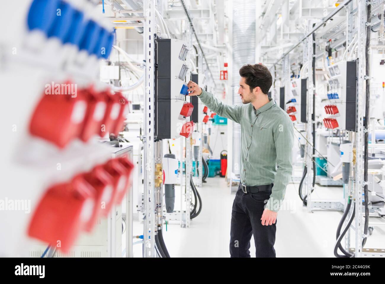 Man examining socket in a factory Stock Photo - Alamy