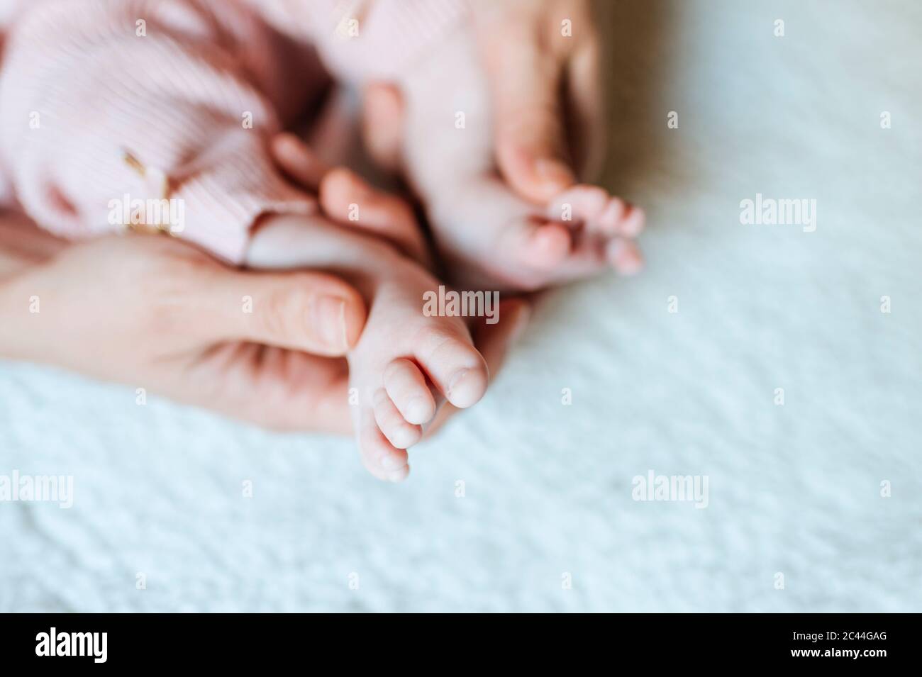 Hand holding baby feet hi-res stock photography and images - Alamy