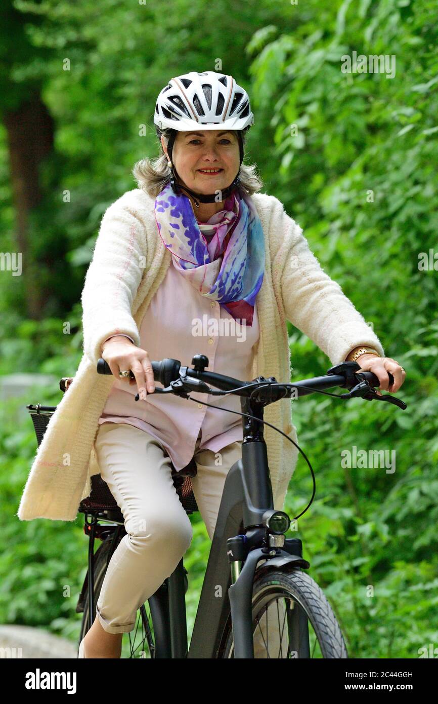 Woman riding an electric bike hi-res stock photography and images - Alamy