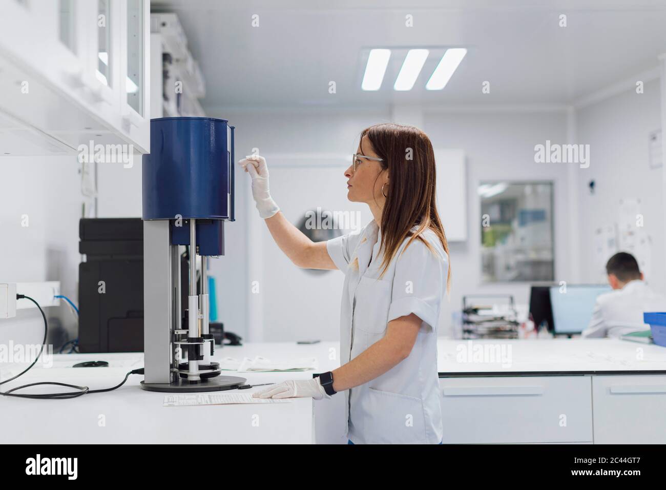 Female scientist using equipment while working at laboratory Stock ...