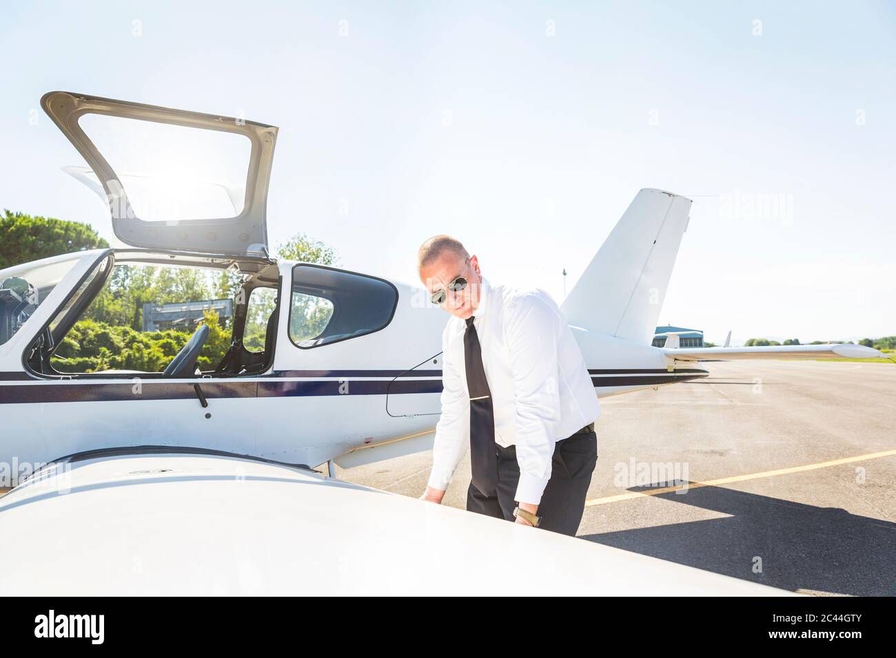 Pilot doing pre flight inspection on his sports plane Stock Photo - Alamy