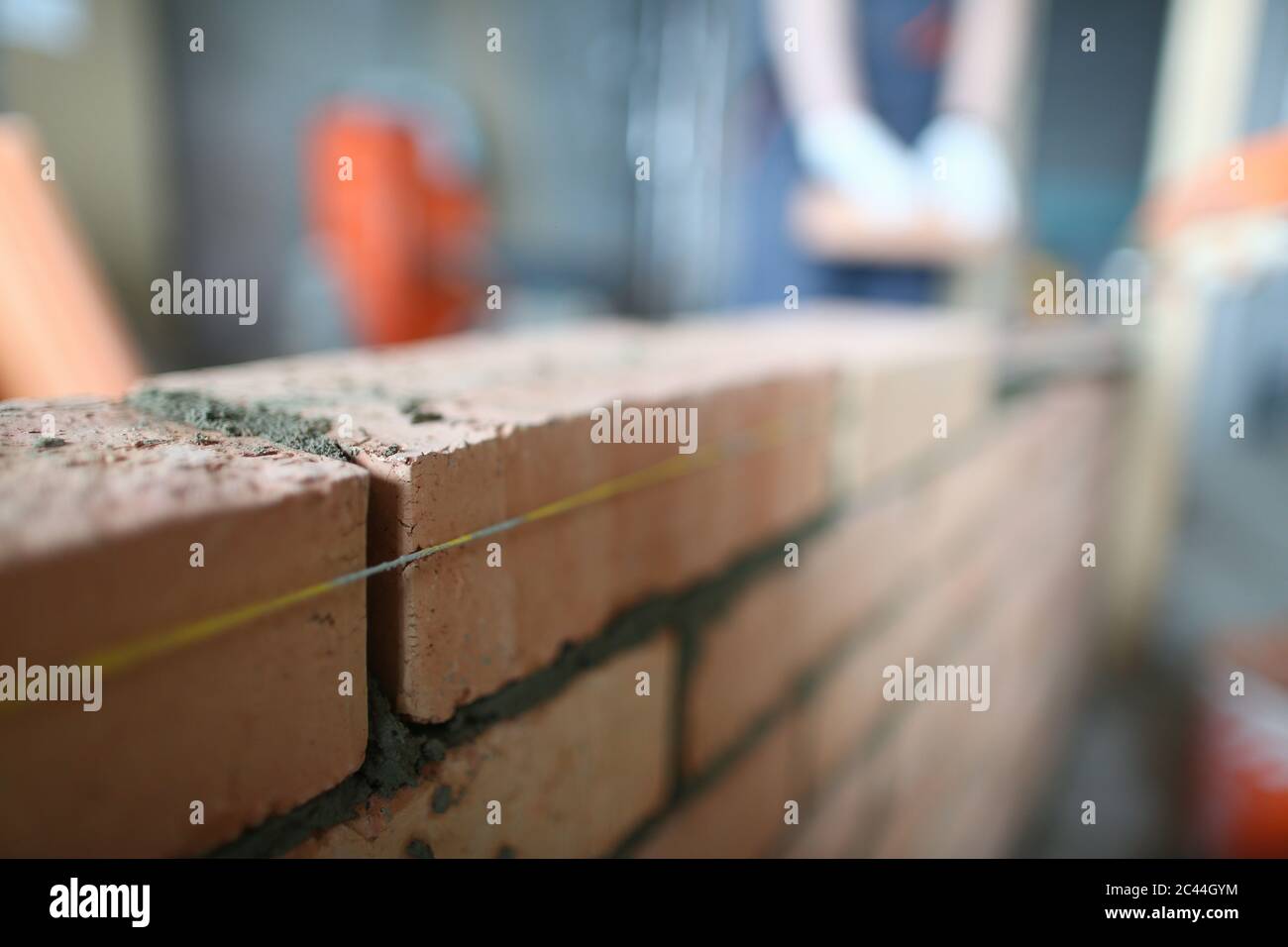 Brick wall with cement at construction site Stock Photo - Alamy