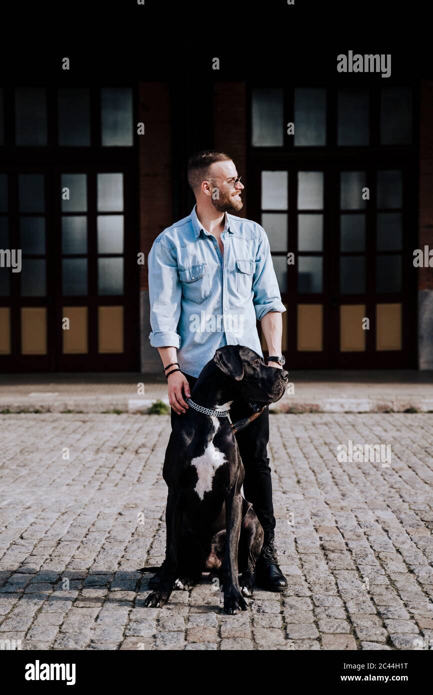 Man and his dog looking at distance Stock Photo - Alamy