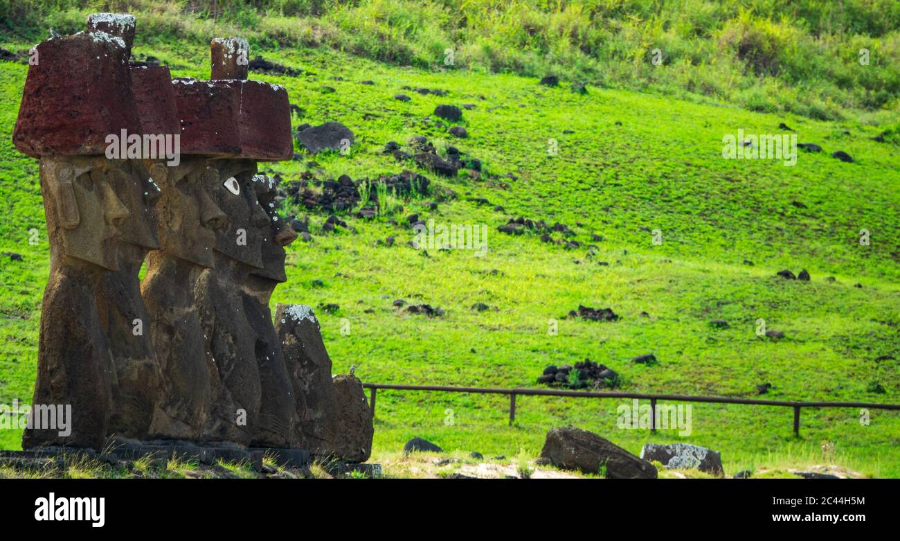 Profile view of moai platform against green Stock Photo - Alamy