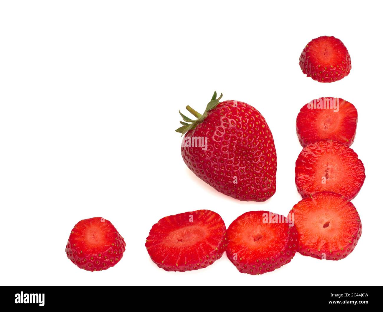 Isolated strawberries. One whole fruit and cut berries on white ...