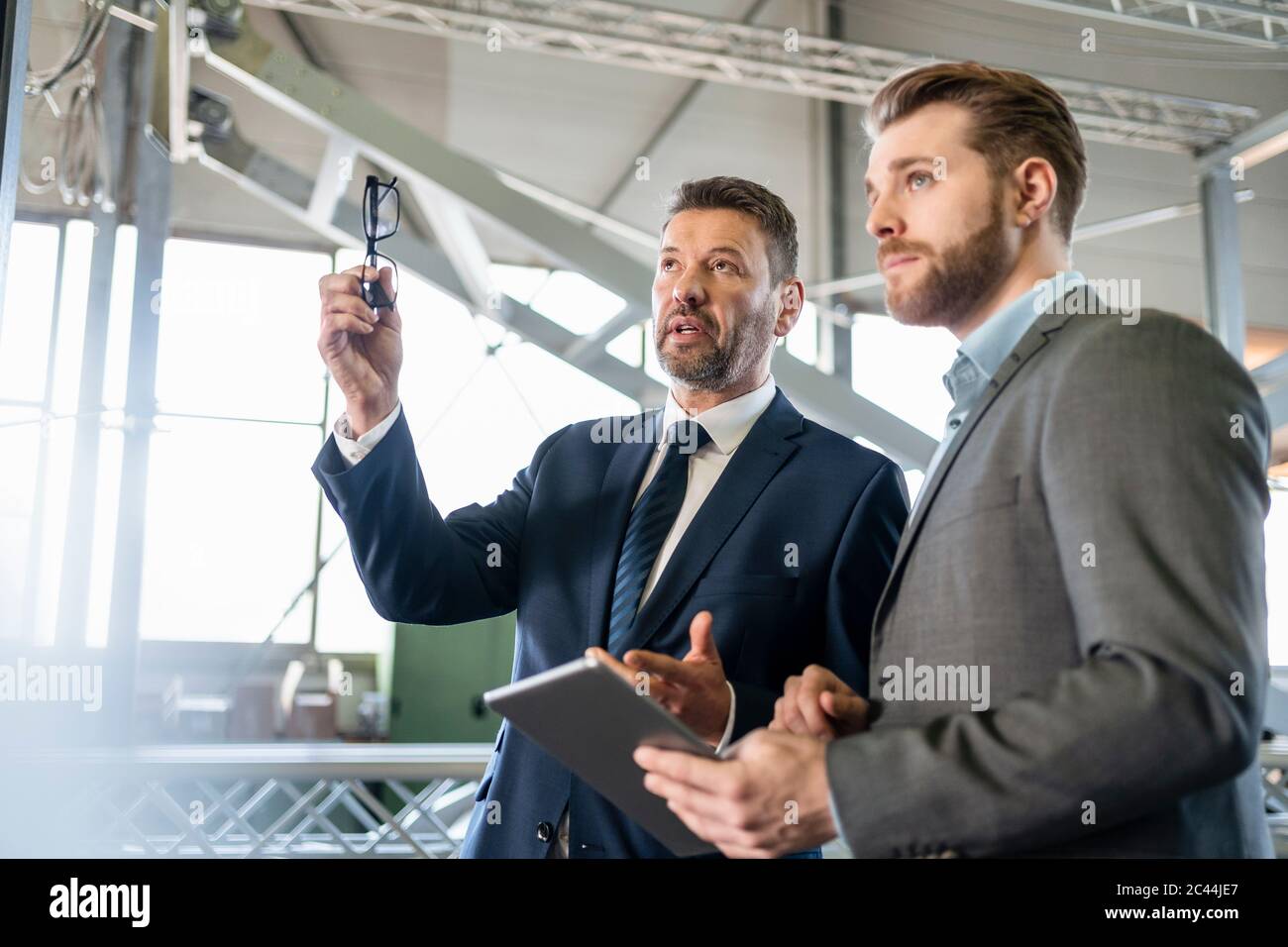Two businessmen having a meeting in a factory Stock Photo - Alamy
